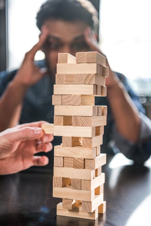 Friends playing jenga game stock image. Image of relationship - 93099659