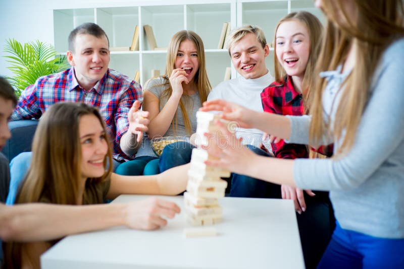 Friends playing jenga stock photo. Image of relationship - 90365006