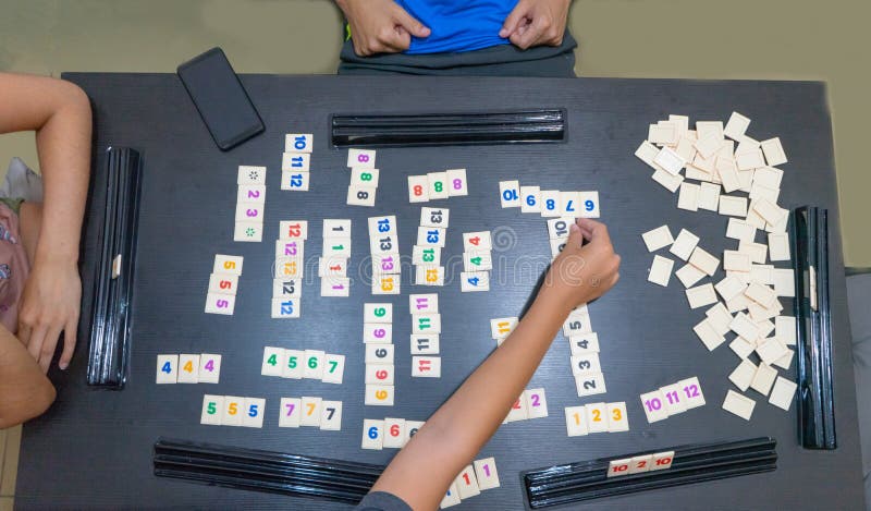 Friends Playing To a Strategy Game Board on a Table. Blocks of Number ...