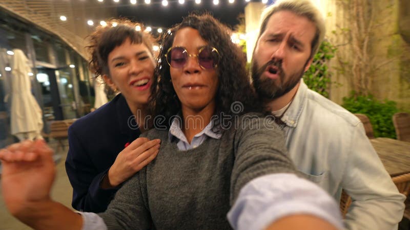 Friends Pulling Funny Faces while Taking Selfie in Night Party Stock ...