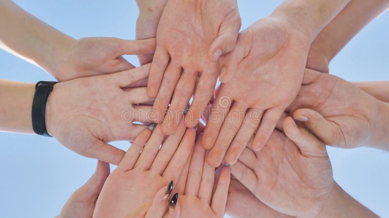 Friends Putting Their Hands Together in a Sign of Unity and Teamwork ...