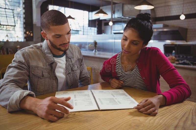 Friends Reading Menu in Cafe Stock Image - Image of front, mixedrace ...