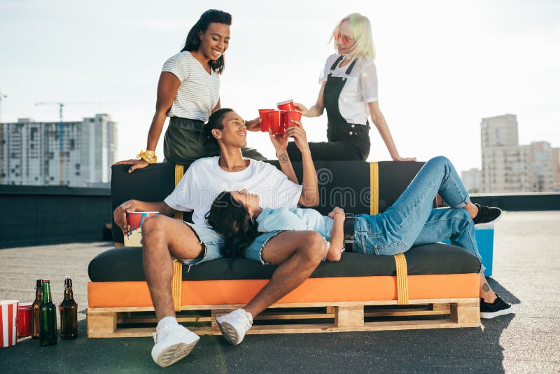 Friends Relaxing on Roof Party Stock Photo - Image of youth, male ...