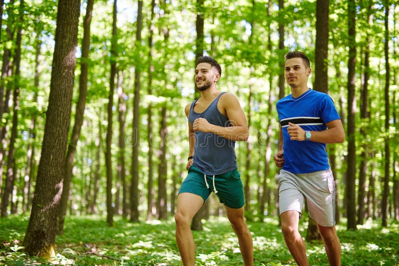 Friends Running through Forest Stock Photo - Image of activity, fast ...