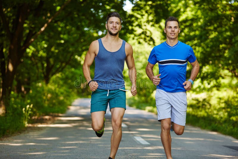 Friends Running through Forest Stock Photo - Image of energy, motion ...