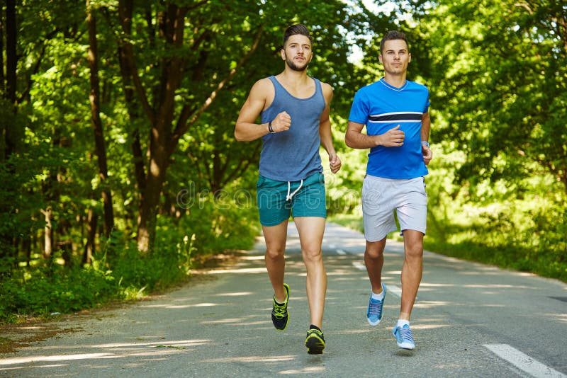 Friends Running through Forest Stock Photo - Image of activity, friends ...