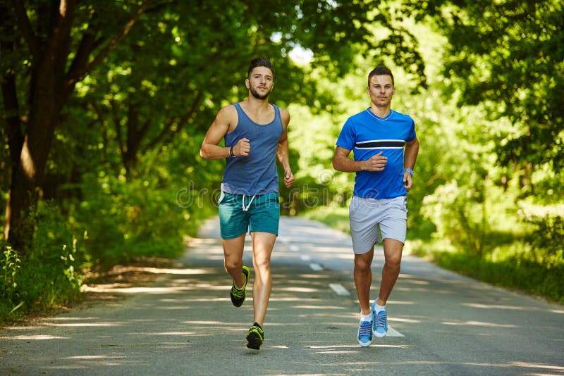 Friends Running through Forest Stock Photo - Image of energy, adult ...