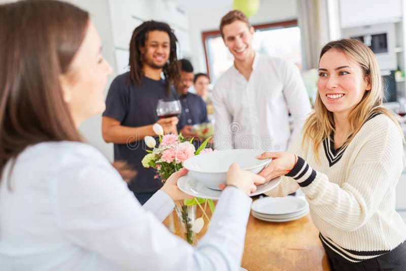 Friends Set Table with Dishes for Eating Together Stock Image - Image ...