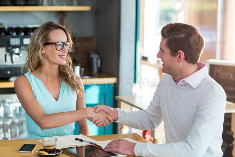 Friends Shaking Hands in CafÃ© Stock Image - Image of cell, connection ...