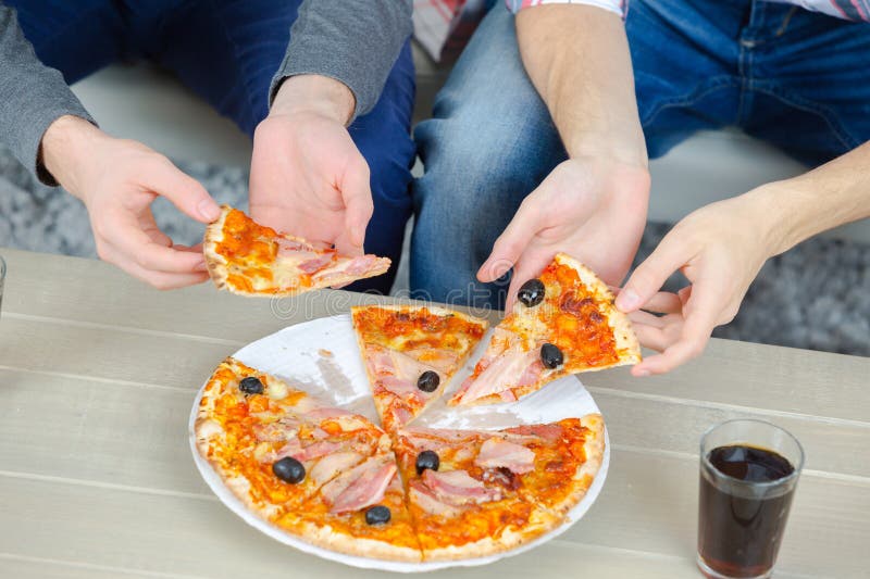 Friends sharing a pizza stock photo. Image of caucasian - 269560972