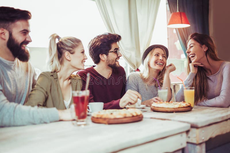 Friends Sharing Pizza in a Indoor Cafe Stock Image - Image of lunch ...