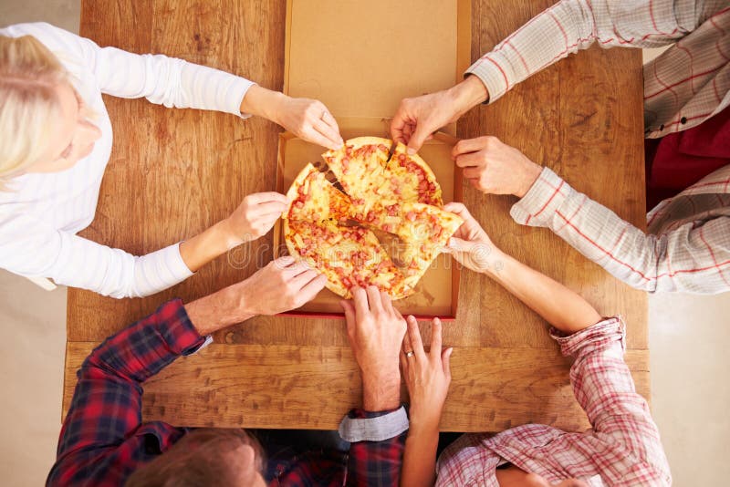 Friends Sharing a Pizza Together, Overhead View Stock Photo - Image of ...