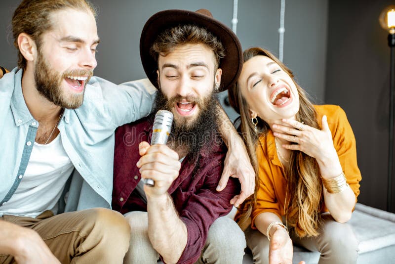 Friends singing at home stock image. Image of caucasian - 150390843