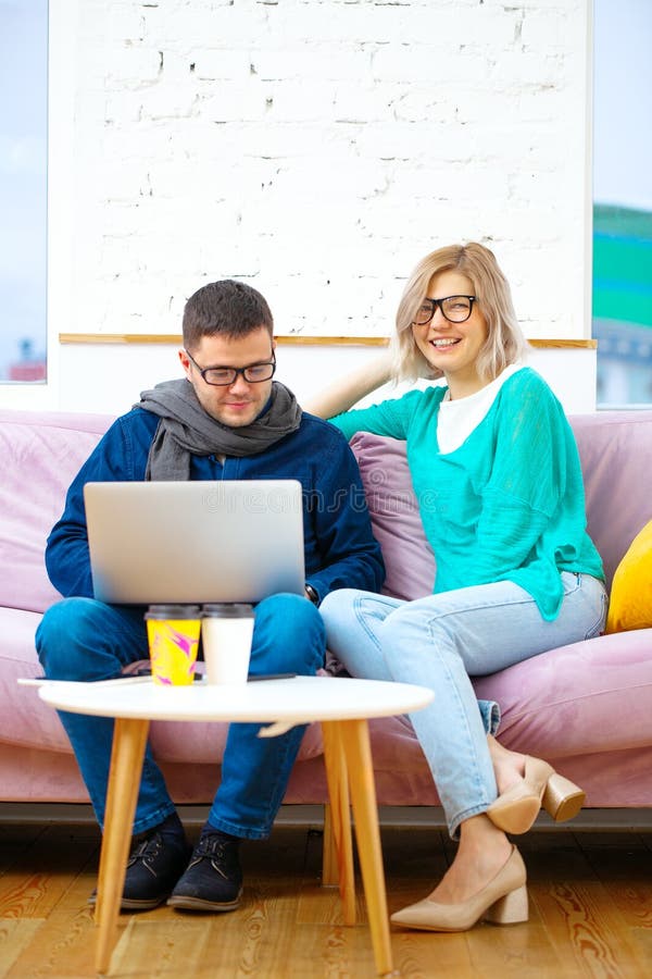 Friends Sit on the Couch, Chatting and Using a Desktop Computer. Stock ...