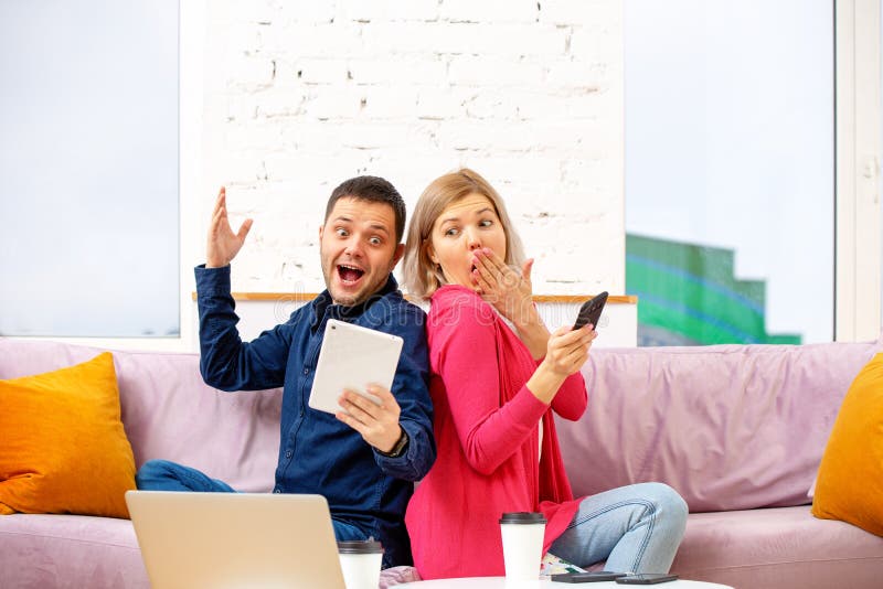 Friends Sit on the Couch, Chatting and Using a Smartphone, Desktop ...