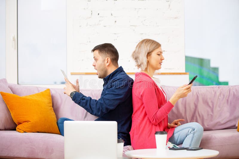 Friends Sit on the Couch, Chatting and Using a Smartphone, Desktop ...