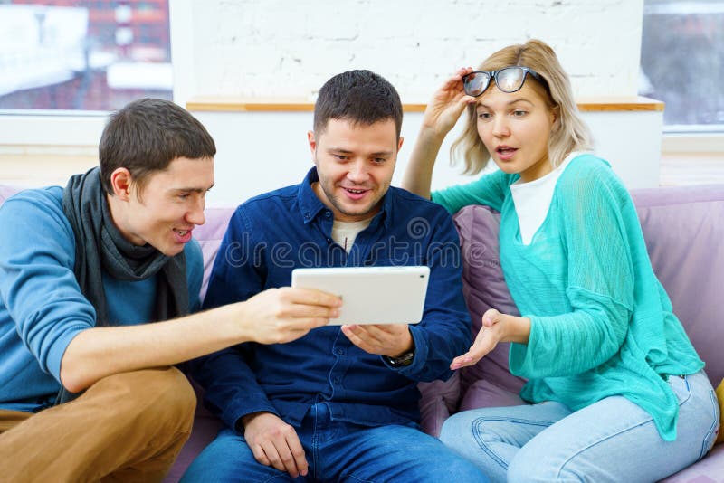 Friends Sit on the Couch, Chatting and Using a Smartphone, Desktop ...