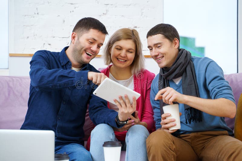 Friends Sit on the Couch, Chatting and Using a Smartphone, Desktop ...