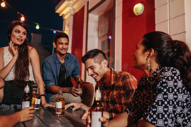 Friends Sitting Around a Table at Rooftop Party Stock Image - Image of ...