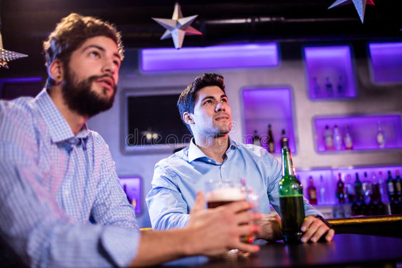 Friends Sitting at Bar Counter and Having Beer Stock Photo - Image of ...