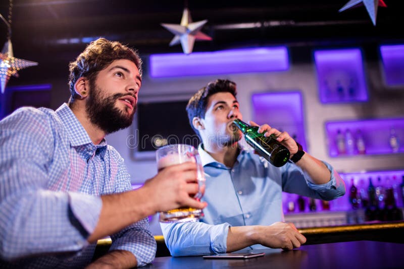 Friends Sitting at Bar Counter and Having Beer Stock Image - Image of ...