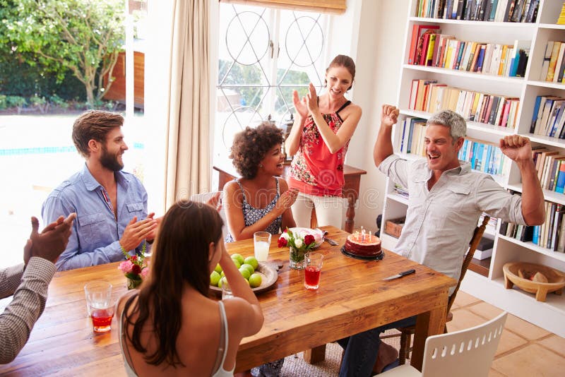Friends Sitting at a Dining Table Celebrating a Birthday Stock Photo ...