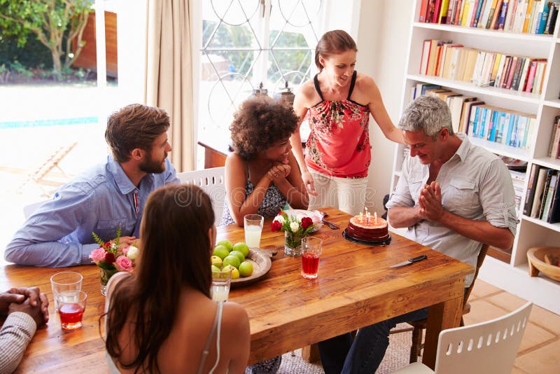 Friends Sitting at a Dining Table Celebrating a Birthday Stock Image ...