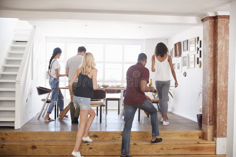 Friends Sitting Down at Table for Dinner Party at Home Together Stock ...