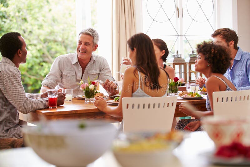 Friends Sitting at a Table Talking during a Dinner Party Stock Photo ...