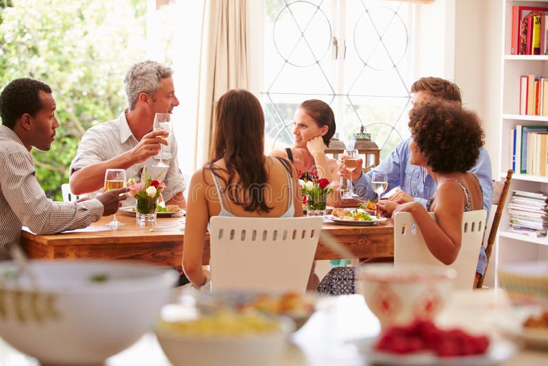 Friends Sitting at a Table Talking during a Dinner Party Stock Photo ...