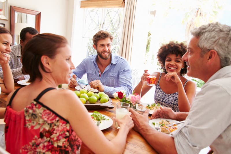 Friends Sitting at a Table Talking during a Dinner Party Stock Photo ...