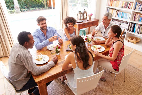 Friends Sitting at a Table Talking during a Dinner Party Stock Photo ...