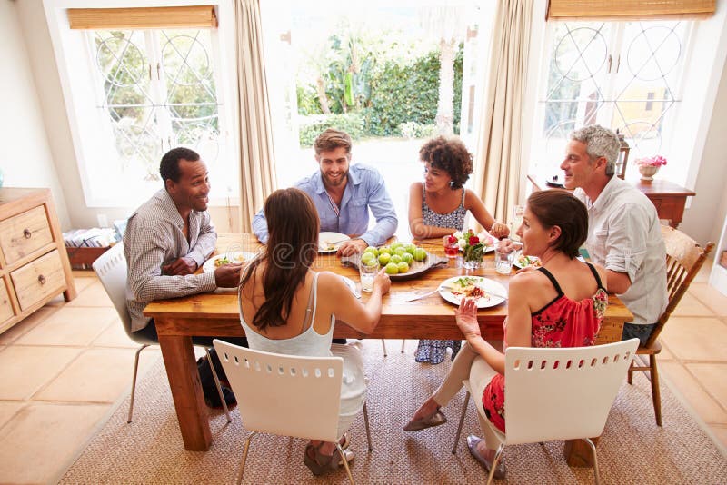 Friends Sitting at a Table Talking during a Dinner Party Stock Photo ...
