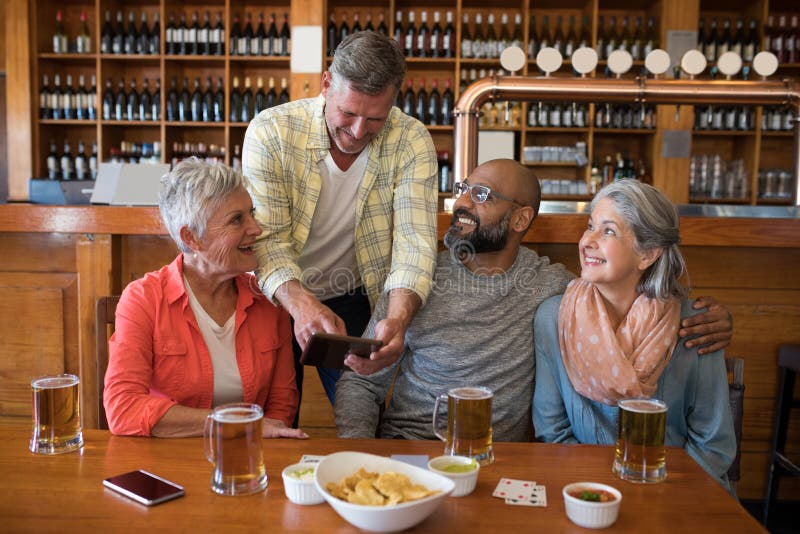 Friends Sitting Together at Bar Stock Photo - Image of clothing, female ...