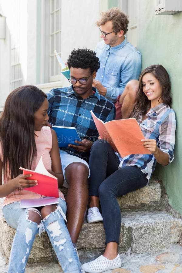 Friends Sitting Together and Reading Book Stock Photo - Image of adult ...