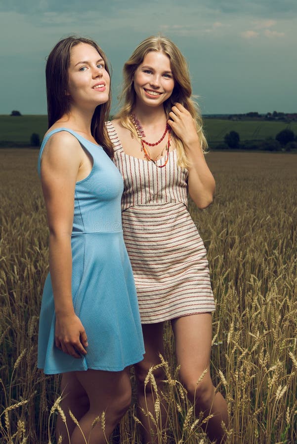 Friends smiling in a field stock image. Image of friendship - 81048855