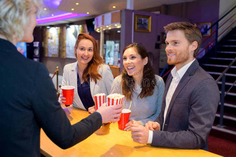 Friends Socializing with Popcorn and Snack Vendor Stock Image - Image ...