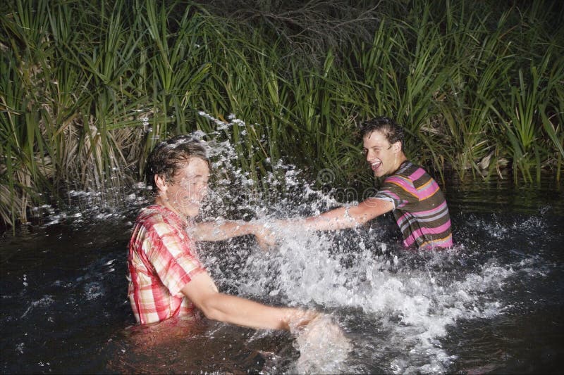 Friends Splashing Water at Each Other Stock Photo - Image of motion ...