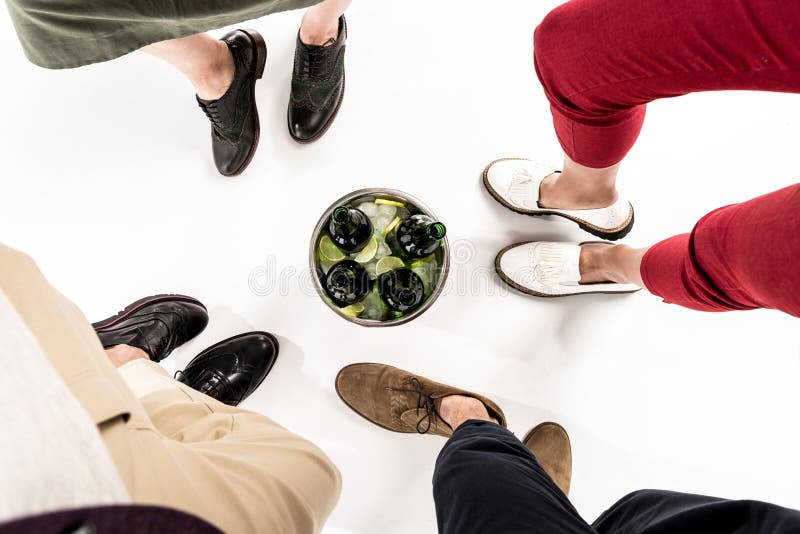 Friends Standing Around Bucket Full of Ice and Beer Bottles Stock Photo ...