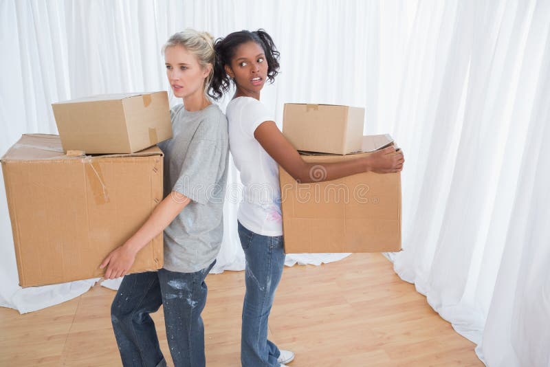 Friends Standing Back To Back Holding Moving Boxes Stock Photo - Image ...