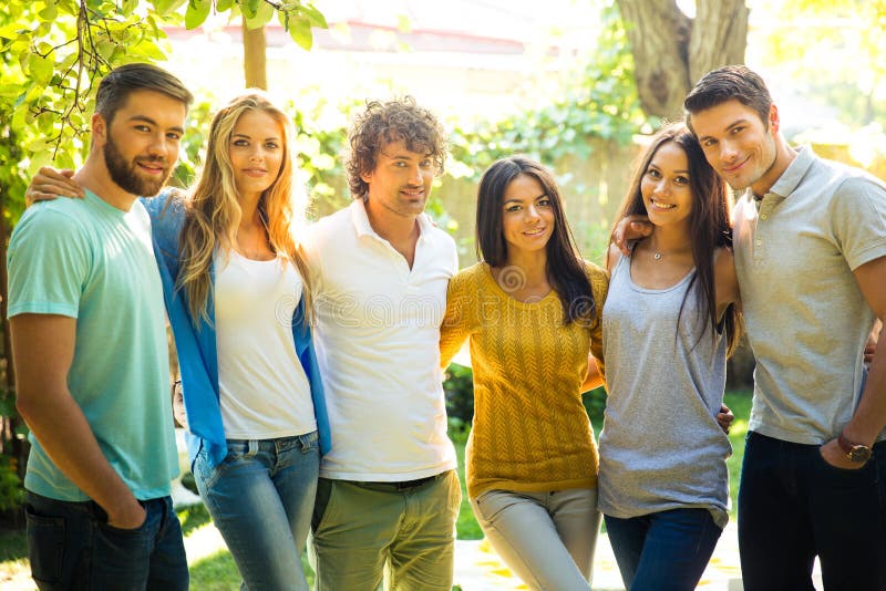 Friends standing outdoors stock photo. Image of casual - 58684326