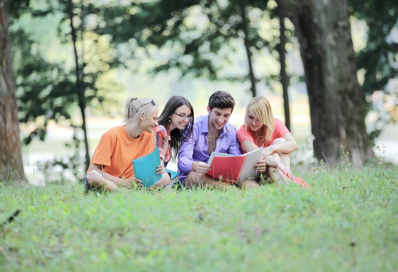 Friends of Students Read Books Sitting on the Lawn in the Park Stock ...