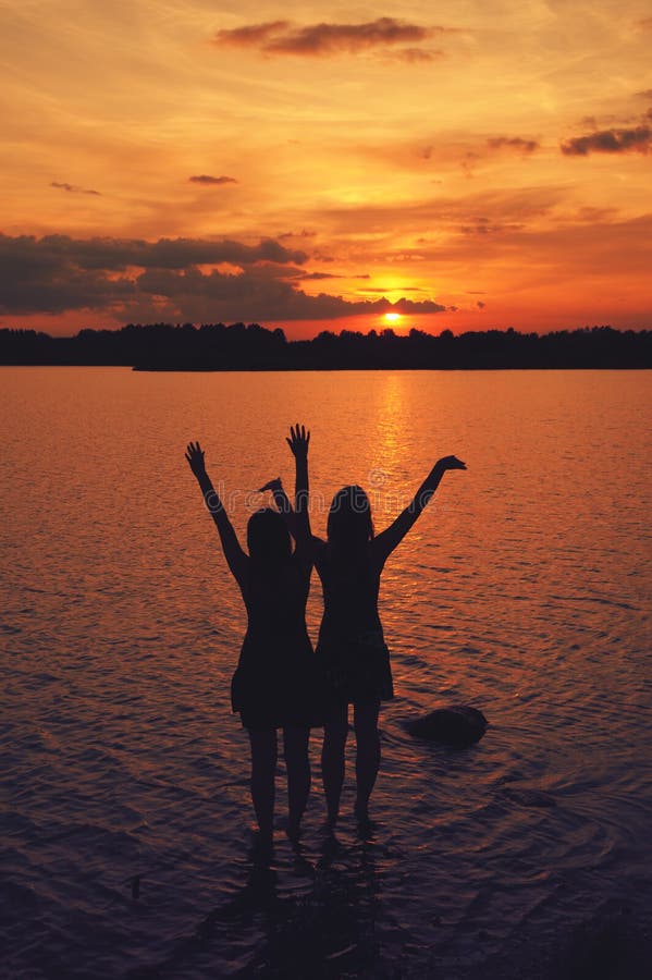 Friends at sunset stock image. Image of togetherness - 55380211