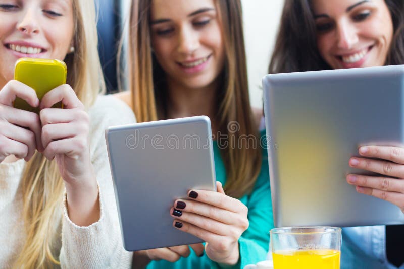 Friends Surfing the Net with Smartphones and Digital Tablets Stock ...