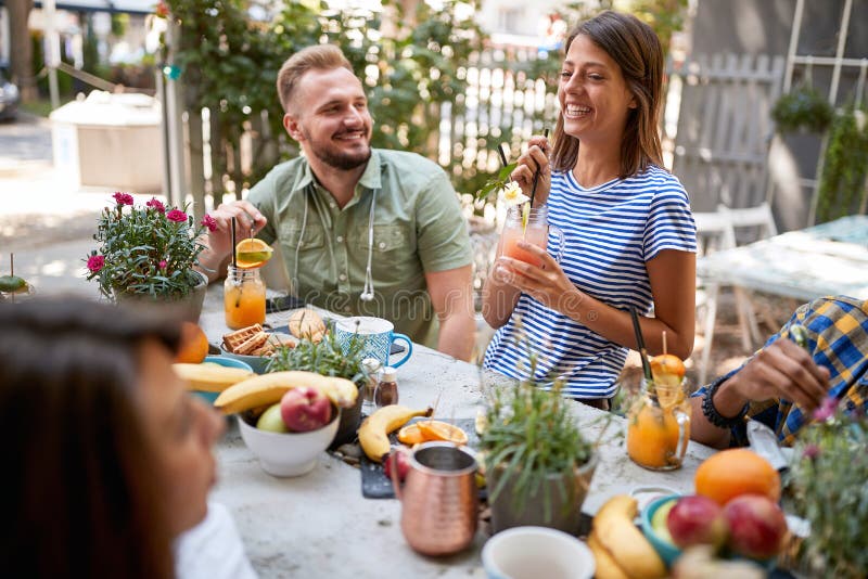 Friends at the Table Outside Drinking Juice and Having Fun Stock Image ...