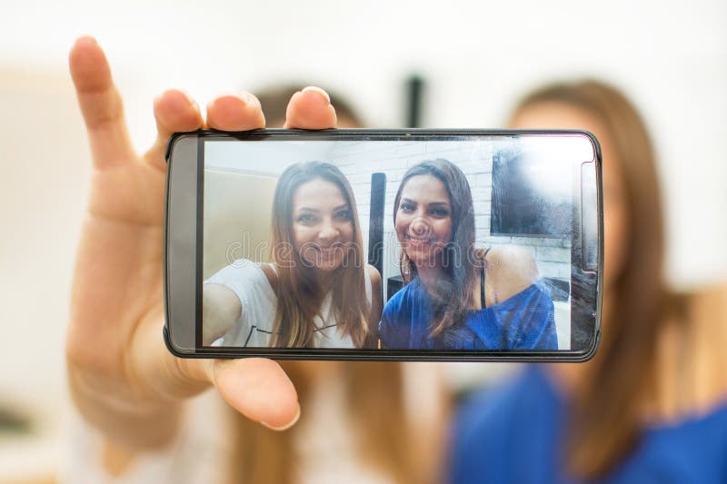 Friends Taking Self Portrait with Smart Phone at Home. Stock Photo ...