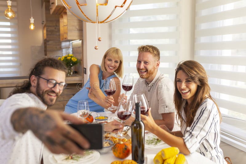 Friends Taking a Selfie while Making a Toast at Dinner Party Stock ...