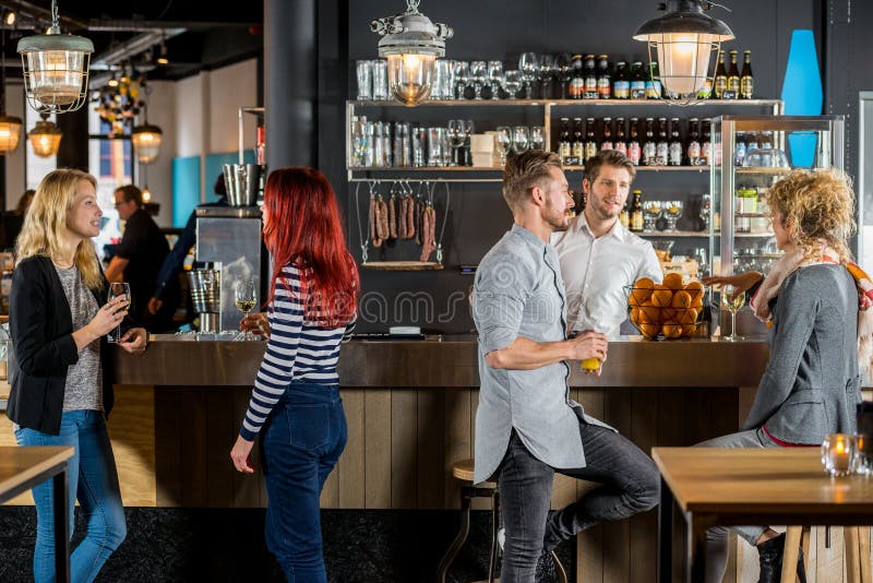 Friends Talking while Having Their Drinks in Bar Stock Image - Image of ...