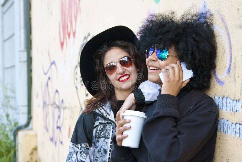 Friends talking by mobile stock photo. Image of modern - 70523574