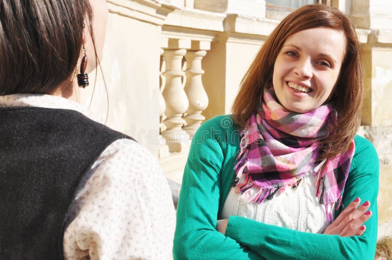 Friends talking outside stock image. Image of friend - 18505153